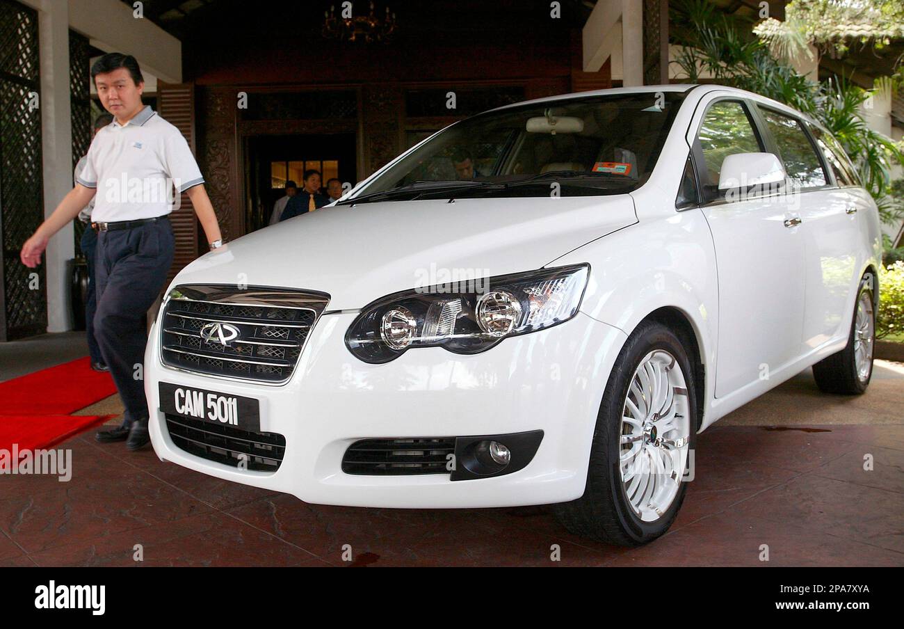 A visitor walks past a Chery model B240 in Cyberjaya, Malaysia, Friday ...