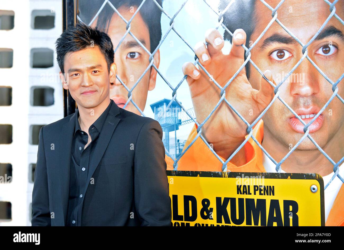 John Cho poses in front of a movie poster as he arrives at the Los ...