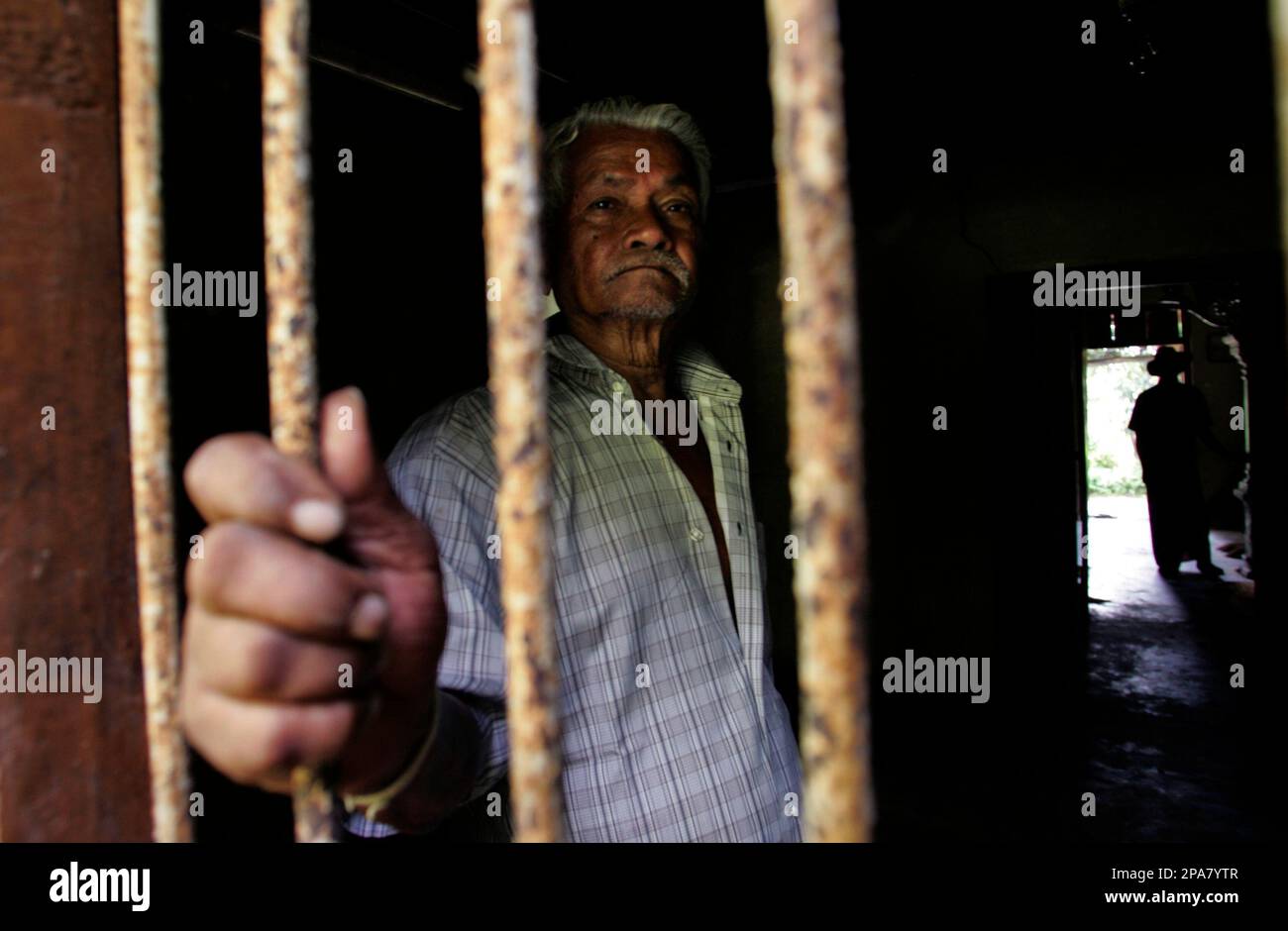 P.P. James looks through a window at his uncle's house in Hipauwa ...