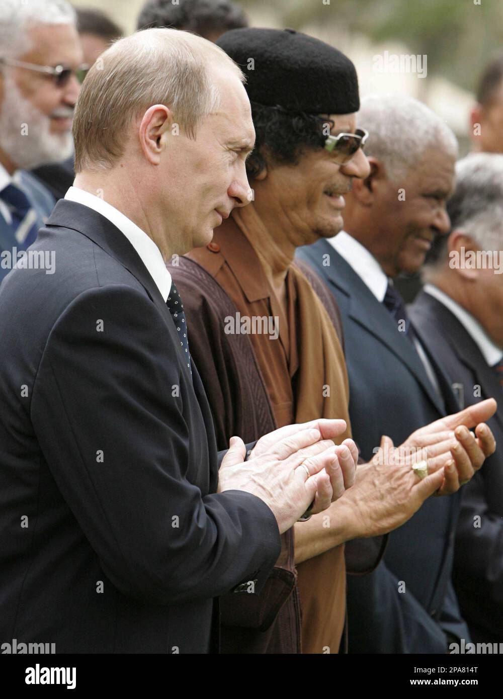 Russian President Vladimir Putin, left, and Libyan Leader Moammar ...