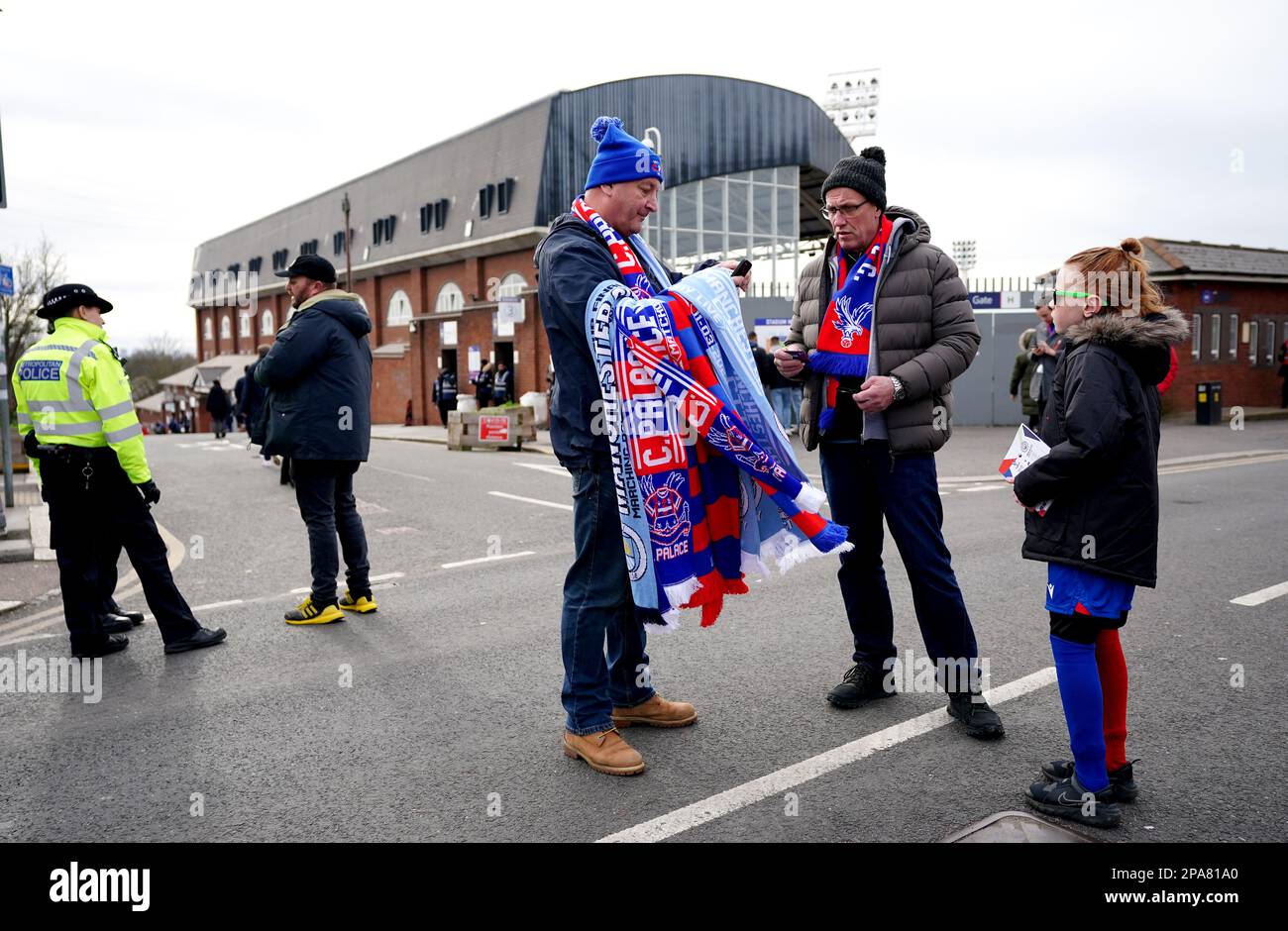 A street vendor sells commemorative match scarves outside of the ...