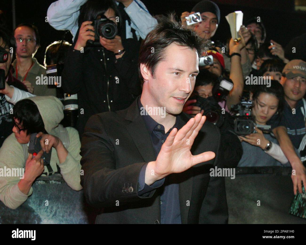 Hollywood actor Keanu Reeves waves as he arrives for the premiere of ...