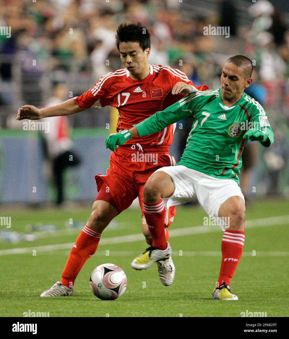 China's Sun Ji (17) loses the ball to Mexico's Jorge Hernandez in a ...