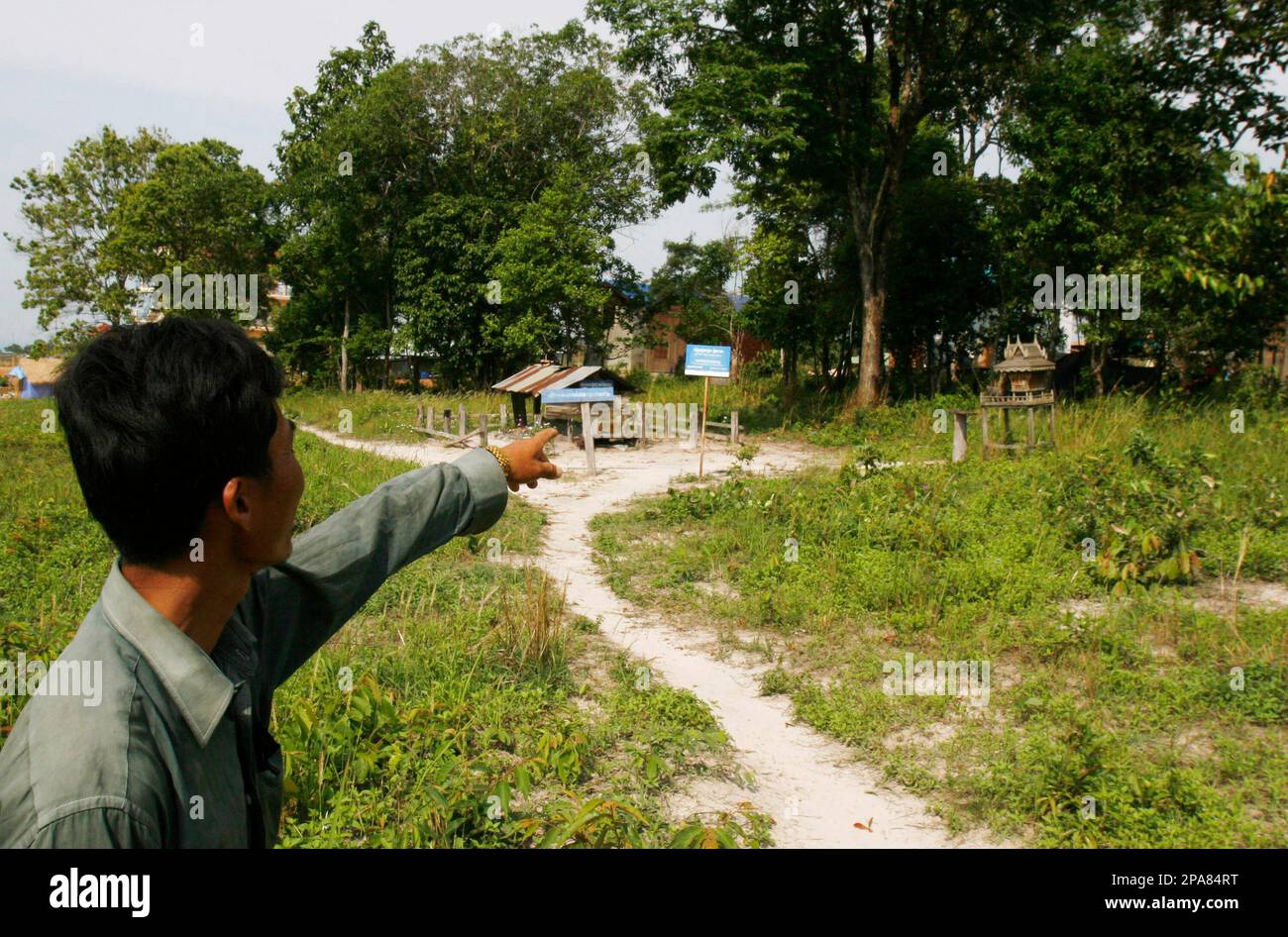 Sieng Kim Chean, a 40-year-old Cambodian villager, points to the ...