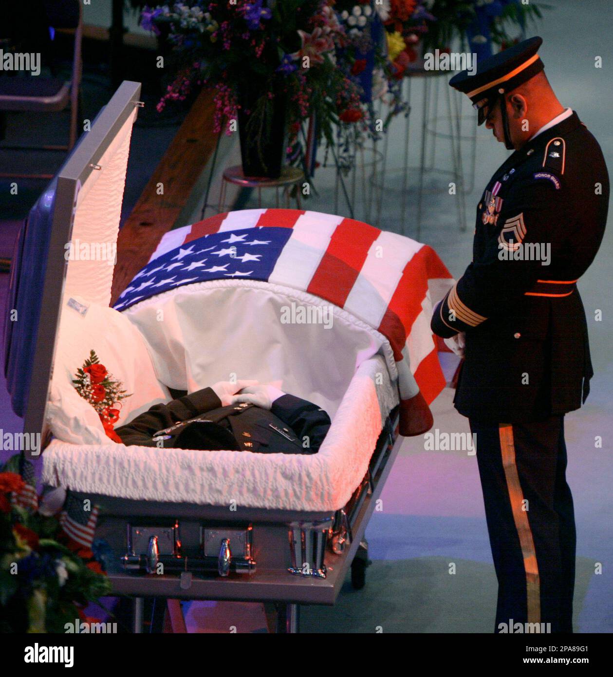 A member of a military honor guard stands near the body of Army Col ...