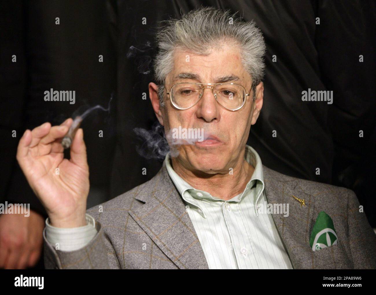 Leader of Italy's Northern League party Umberto Bossi puffs a cigar at ...