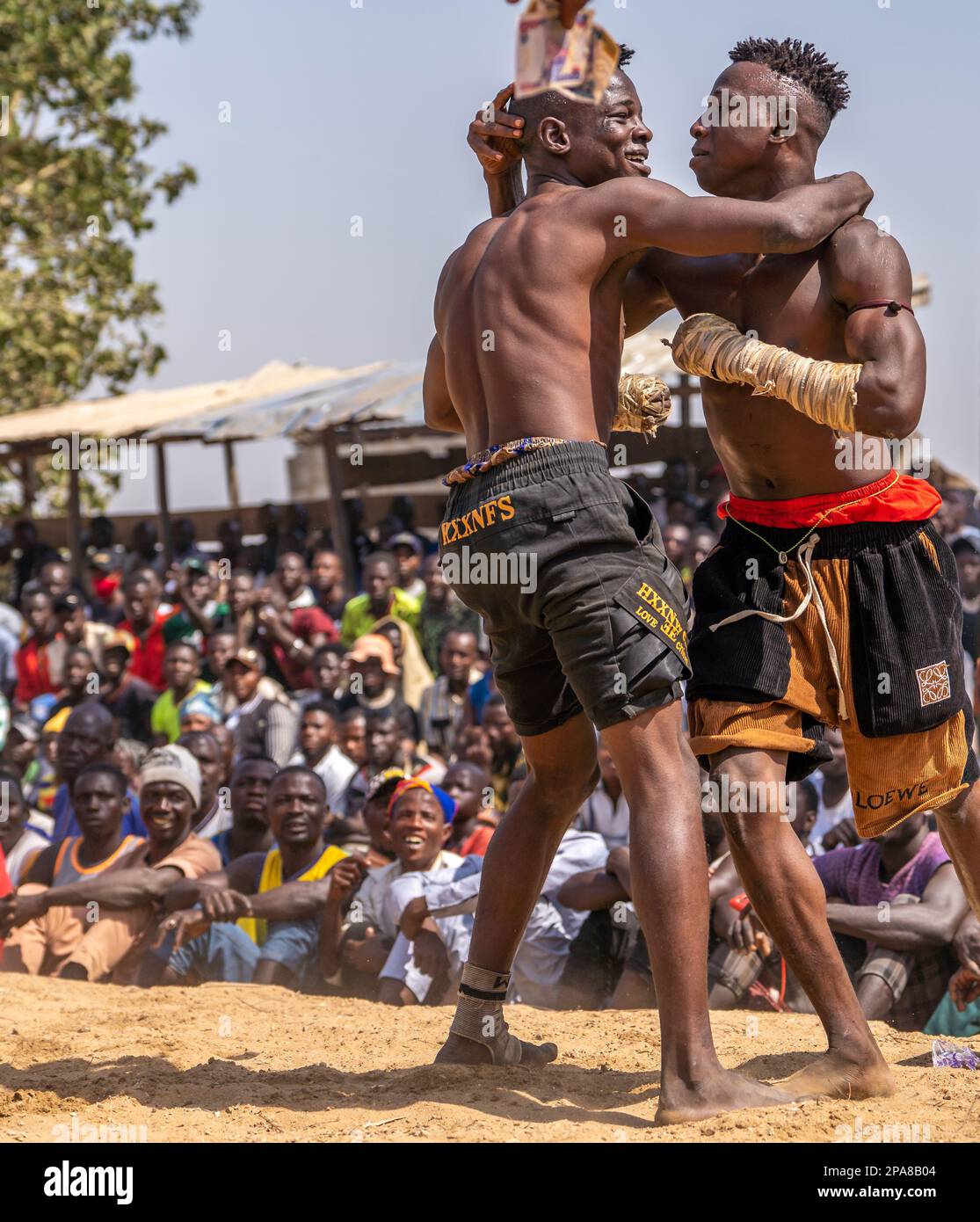 Nigerian fighters embracing each other after the completion of a fight ...