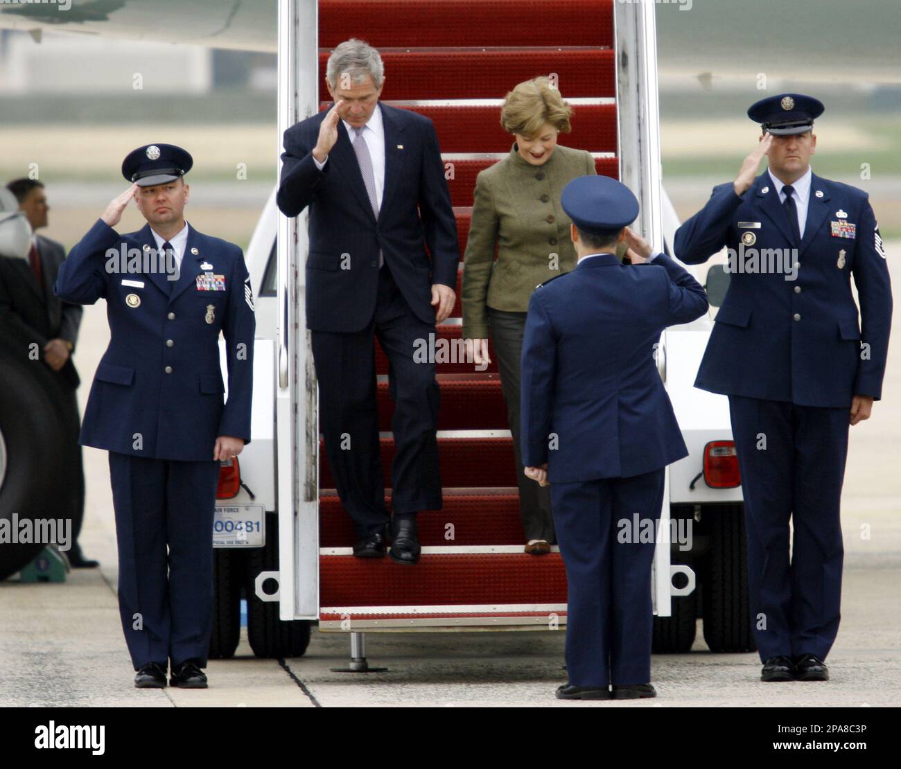 President Bush and first lady Laura Bush walk down the stairs from Air ...