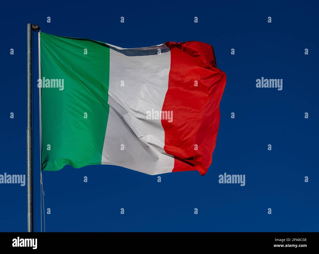 Italian flag, tricolour of Italy waving over blue sky. Isolated on blue ...