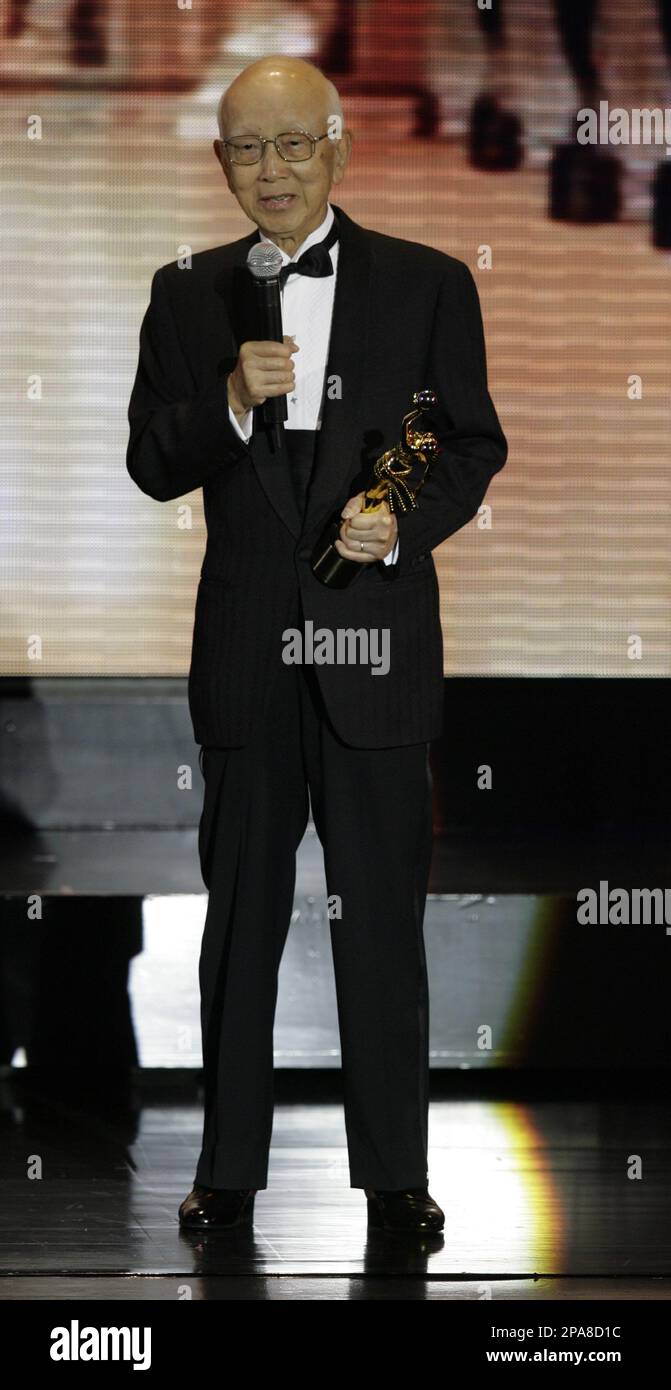Hong Kong movie maker Raymond Chow, looks on, after being awarded with ...