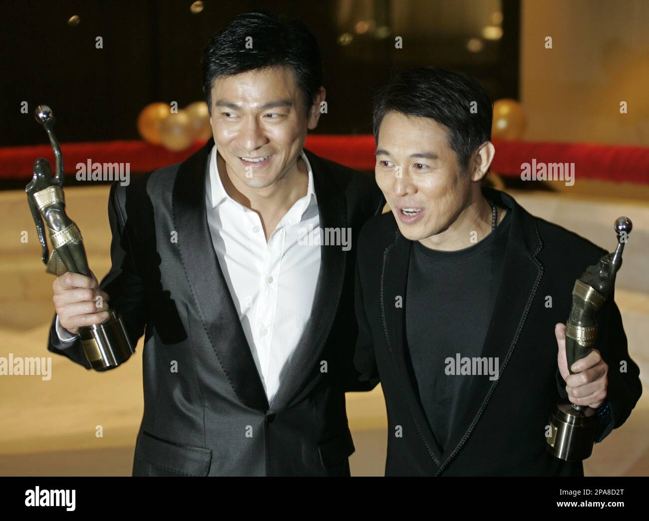 Chinese actor Jet Li, right, holds his Best actor trophy for the movie ...