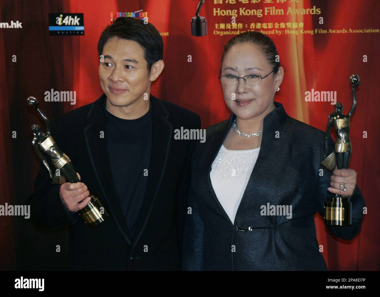 Chinese actress Si Qin Gao Wa and Chinese actor Jet Li hold trophies ...