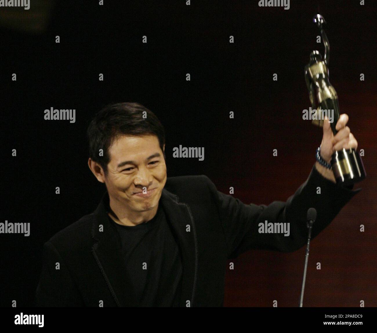 Hong Kong movie actor Jet Li, holds the trophy after ceing awarded the ...