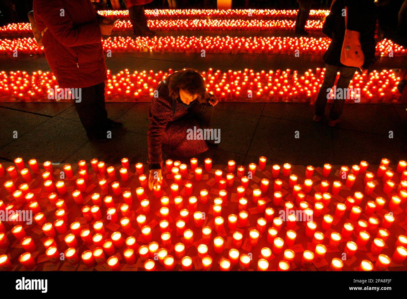 People light candles at Potsdamer Platz, to commemorate the 4646 ...