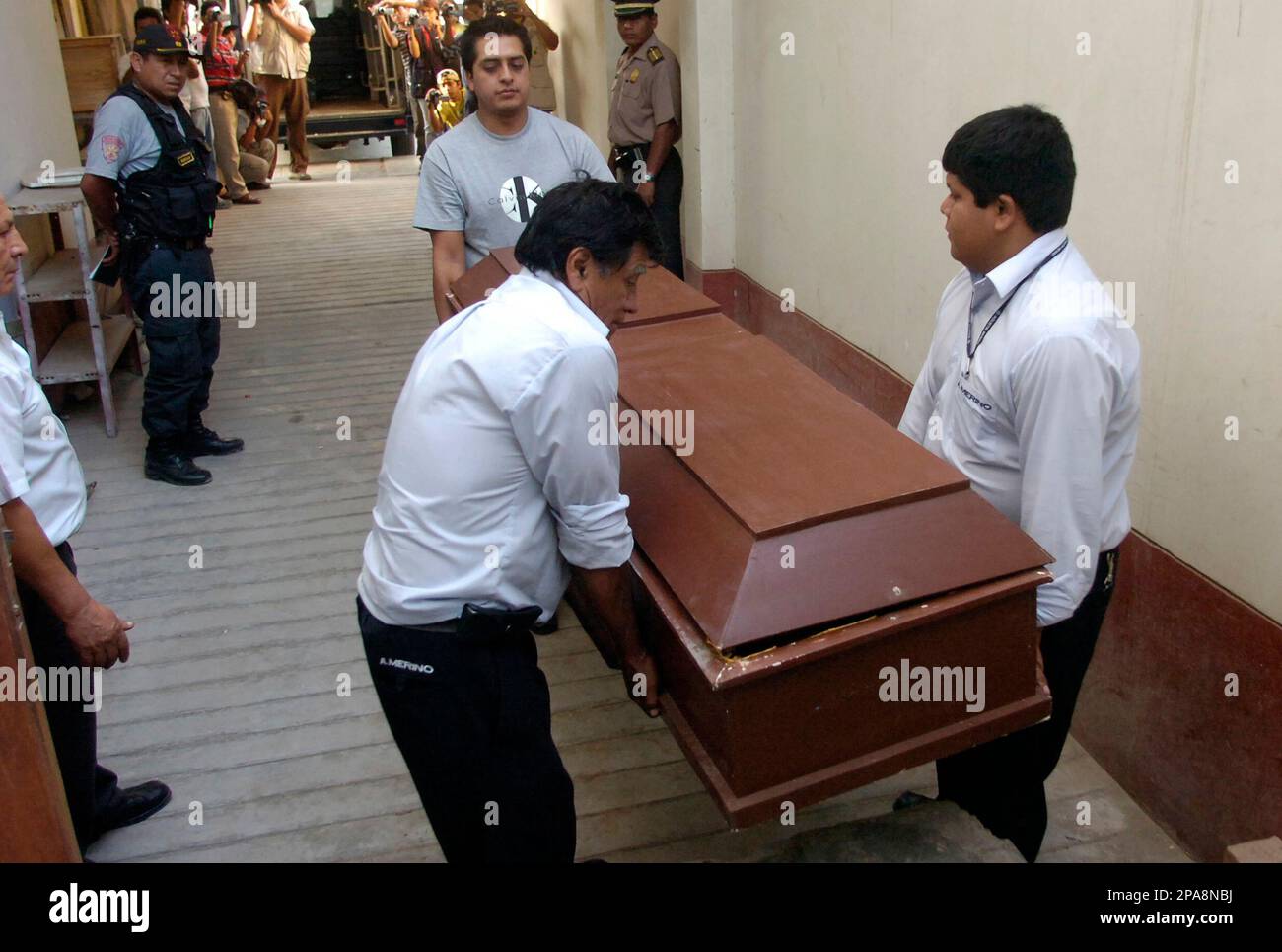 Workers carry the coffin containing the body of one of five French ...