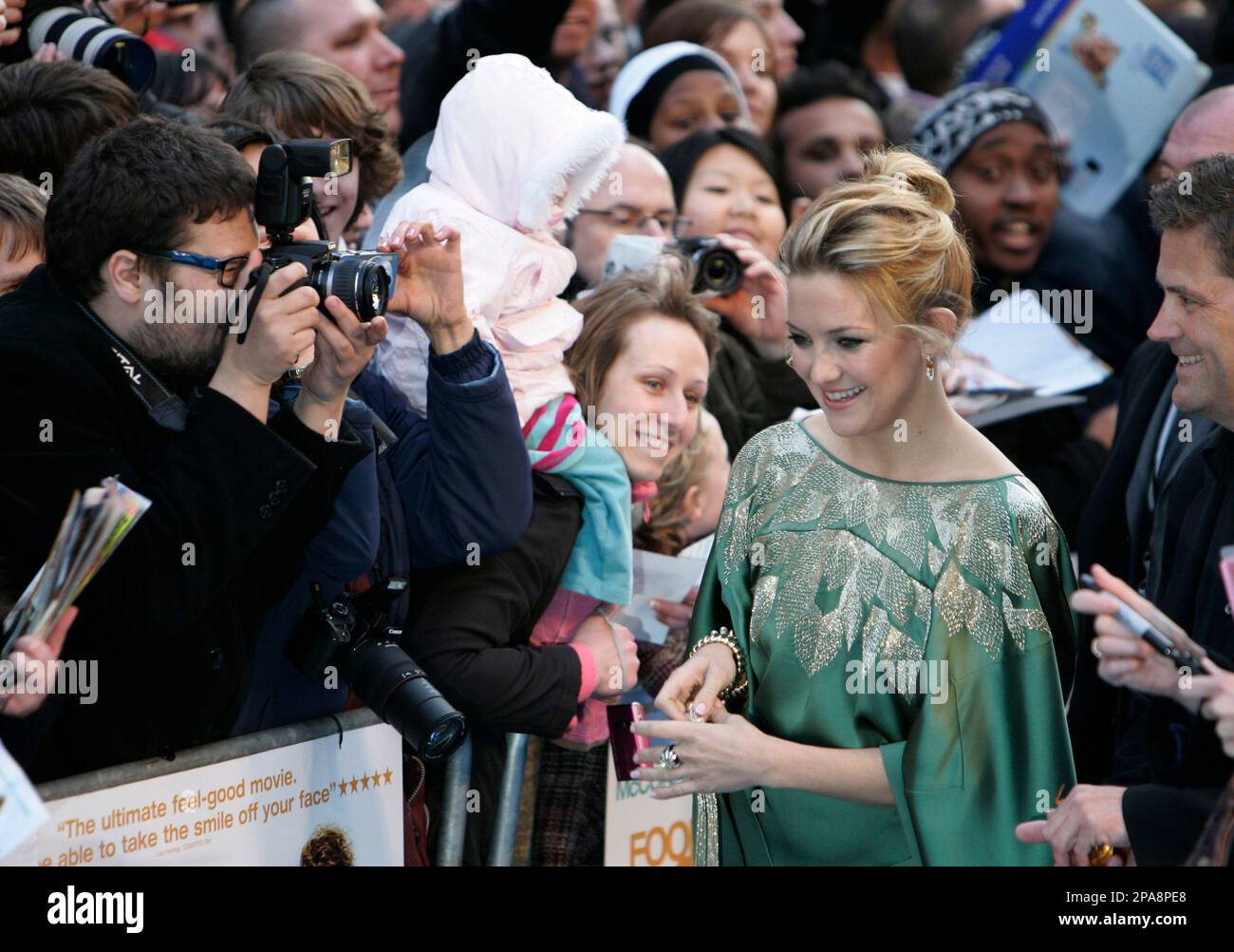 U.S. actress Kate Hudson signs autographs for fans as she arrives for ...