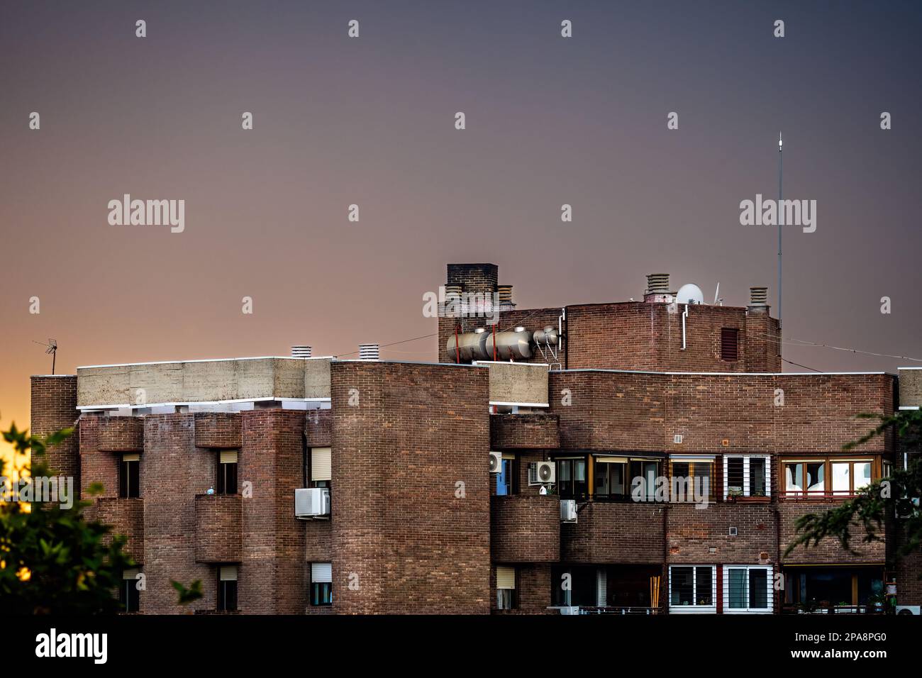 Residential brick building in the city against dark cloudy sky. Real ...