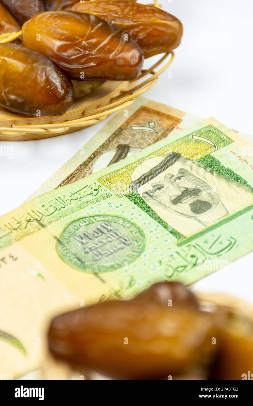 Close-up of Algerian royal dates on a wooden plate. Saudi Arabia Money ...
