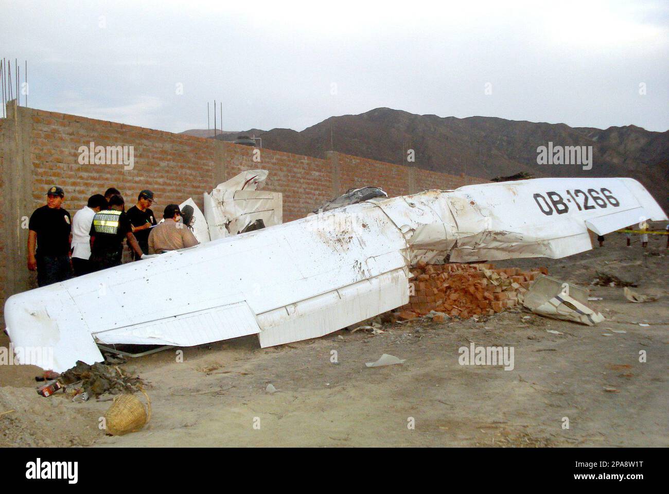 Peruvian police work at the site where a plane crashed in Nazca, Peru ...