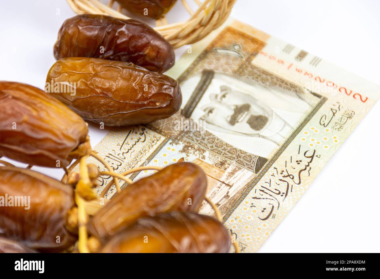 Close-up of Algerian royal dates on a wooden plate. Saudi Arabia Money ...