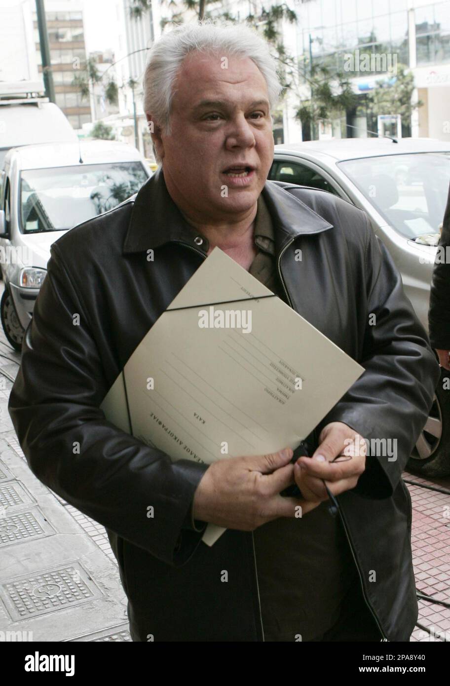 Greece's Olympic weightlifting coach Christos Iakovou walks before he ...