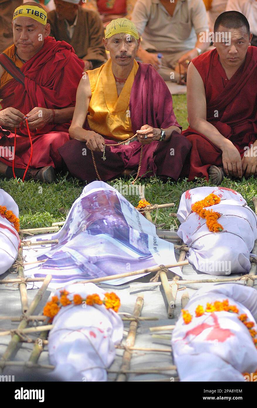 Tibetan monks offer prayers during a mock funeral for Tibetans who ...