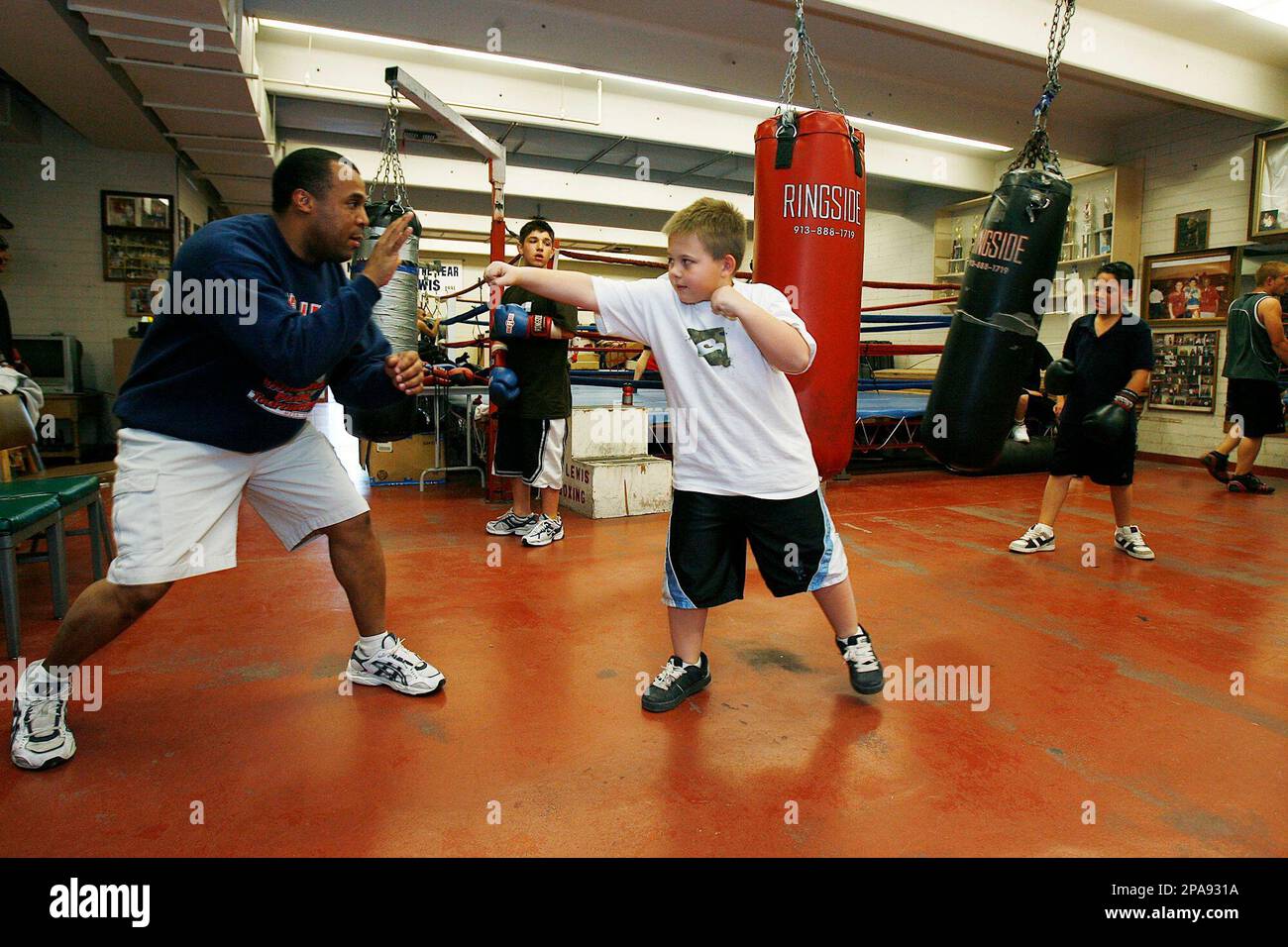 Joshua Benjamin, left, executive director at the Gene Lewis Boxing Club ...