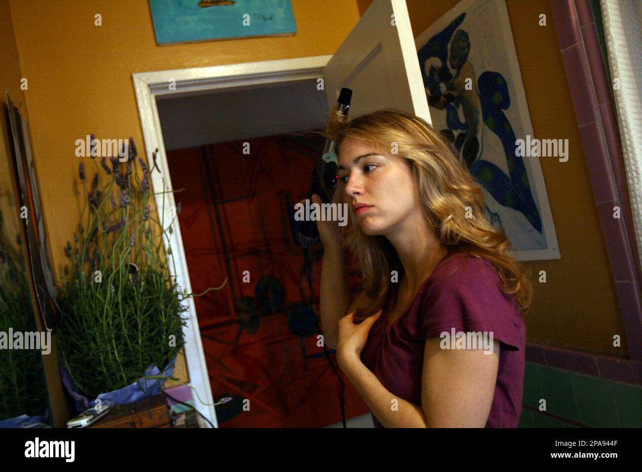 **FOR USE WITH AP LIFESTYLES** Kaitlin Ferrell dries and styles her ...