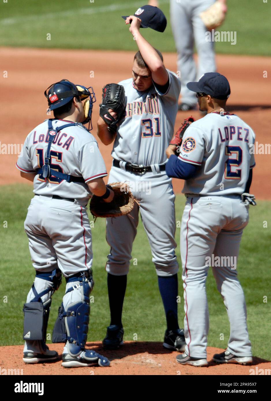 Washington Nationals' pitcher John Lannan, center, talks with catcher ...