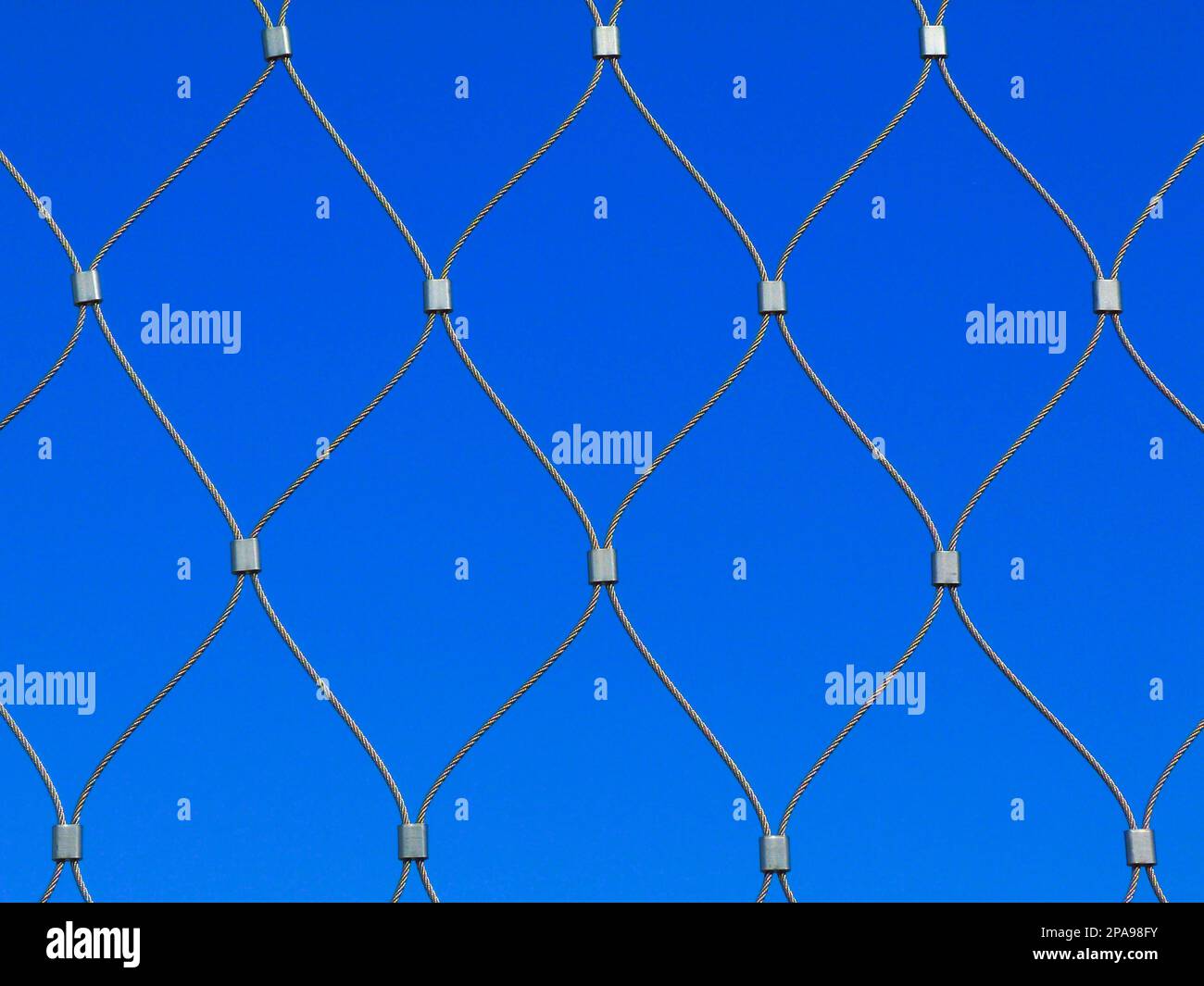 stainless steel twisted wire cable fence closeup. diamond pattern shape ...
