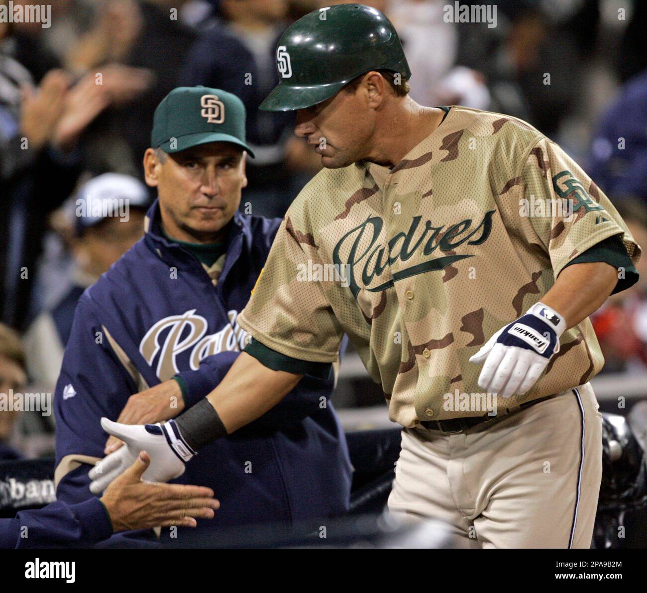 San Diego Padres' Brian Giles is congratulated by teammates as manager ...