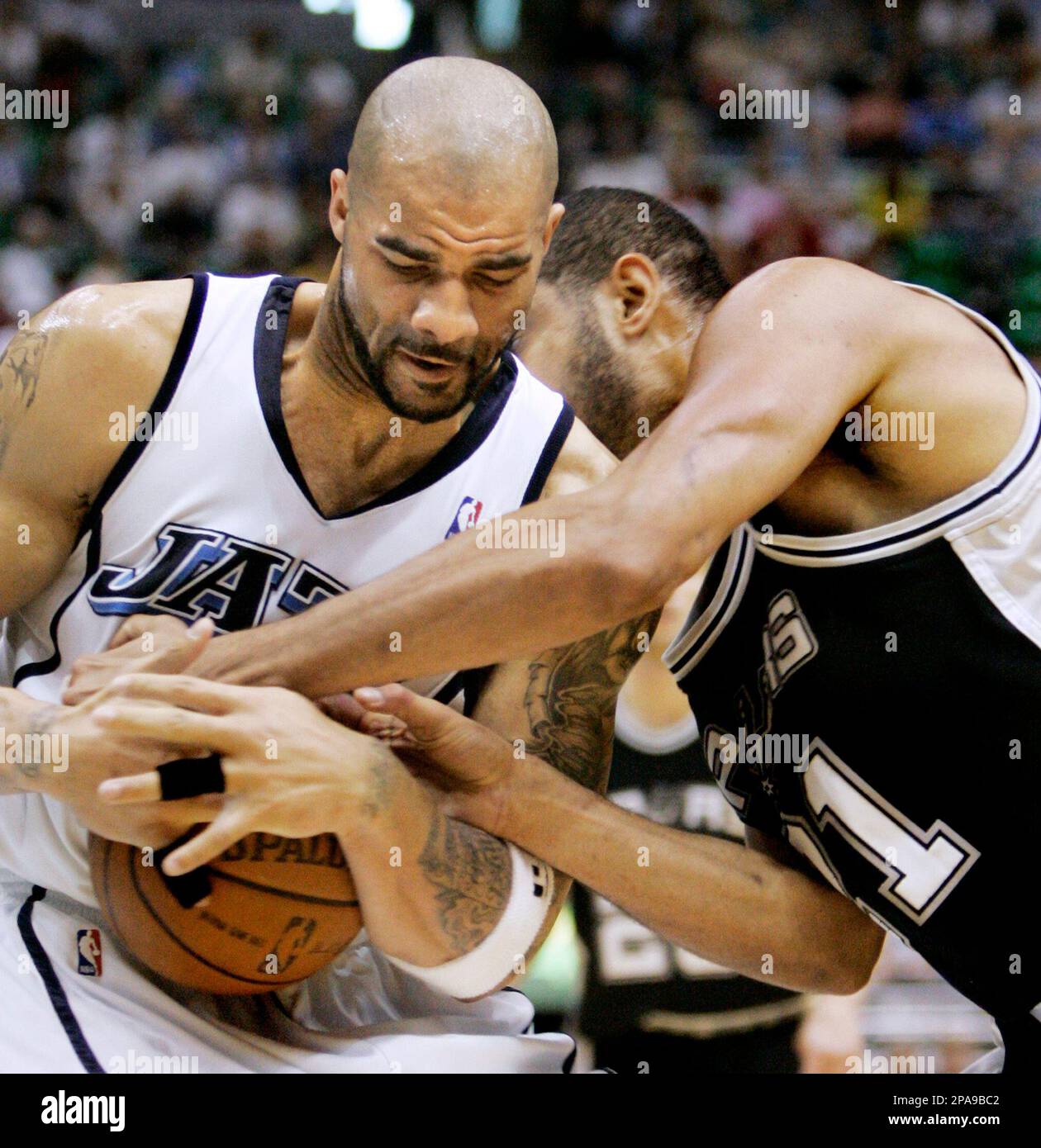 Utah Jazz forward Carlos Boozer, left, rips the ball out of the hands ...