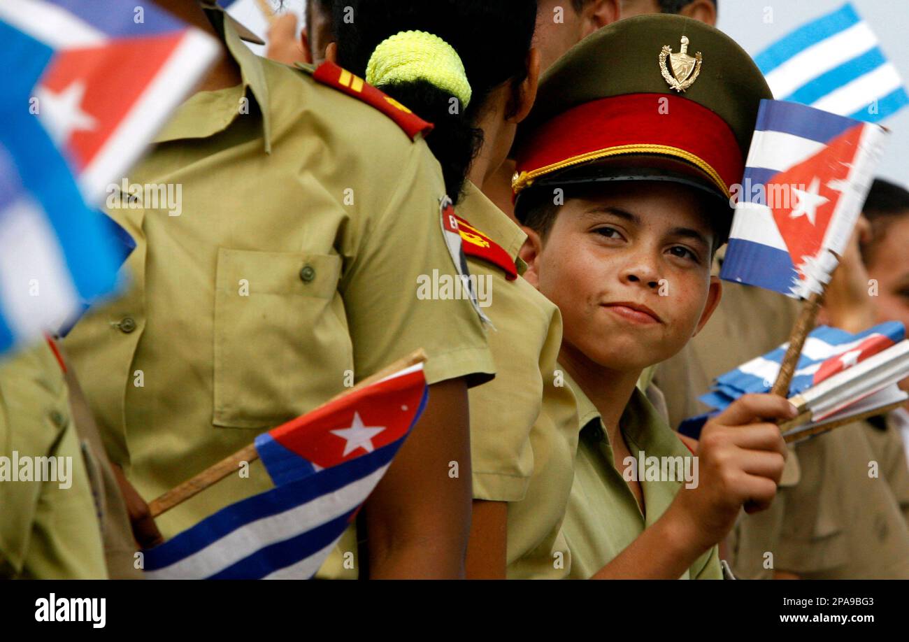 A military cadet waves a Cuban flag during a ceremony to mark the 46th ...