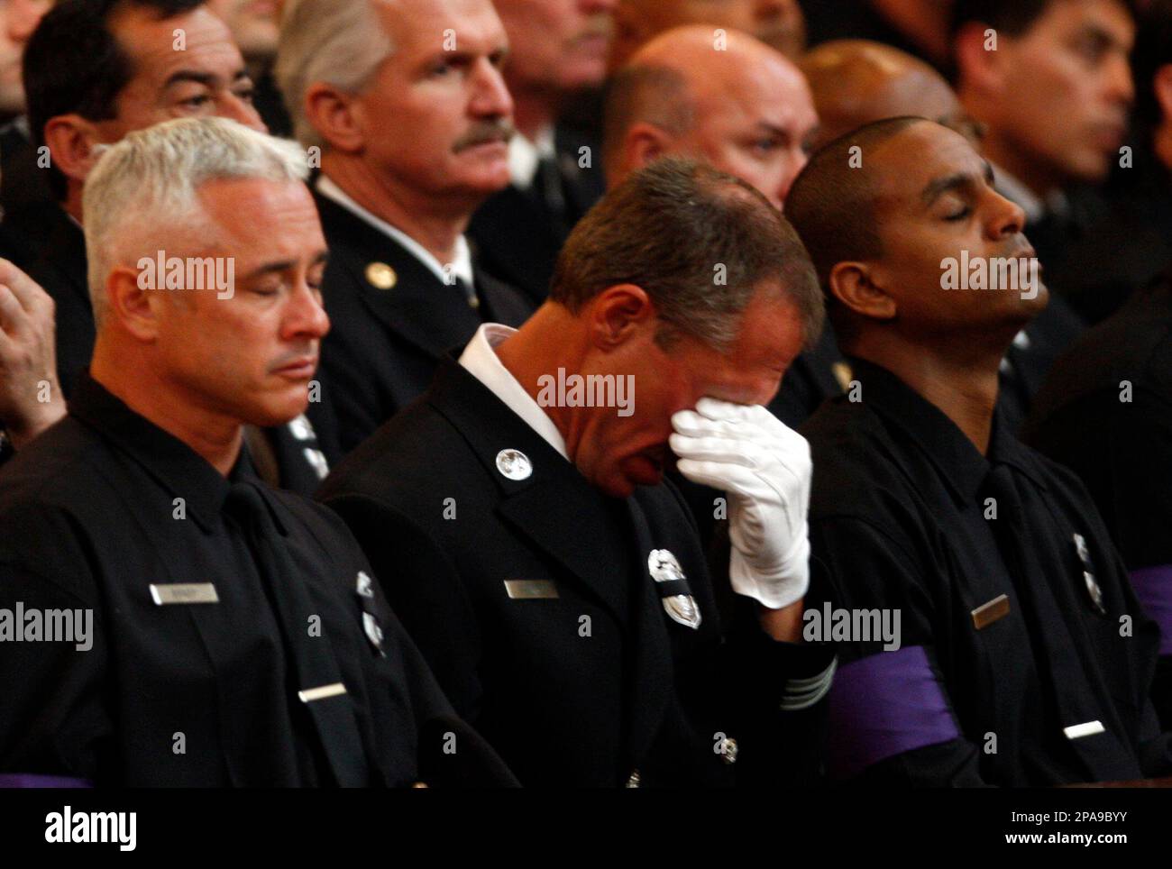 The casket of L.A. firefighter Brent Lovrien is carried to the ...