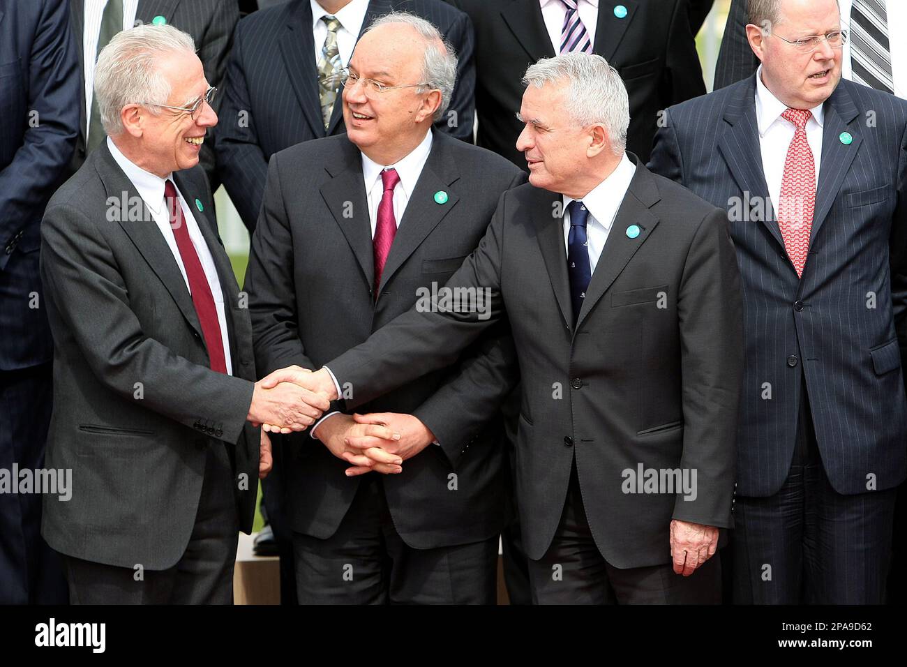 Italy's Finance Minister Tommaso Padoa-Schioppa, left, shakes hands ...