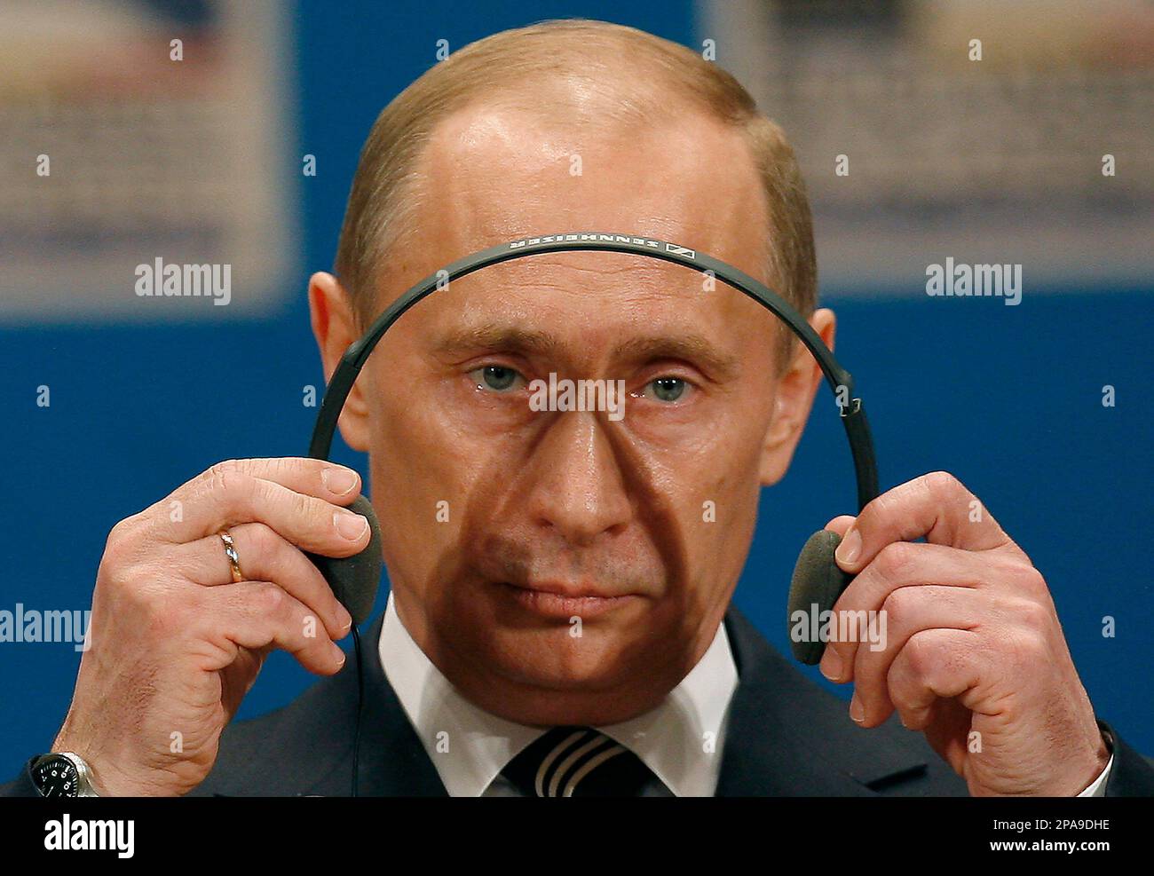 Russian President Vladimir Putin dons his headphones during a press ...