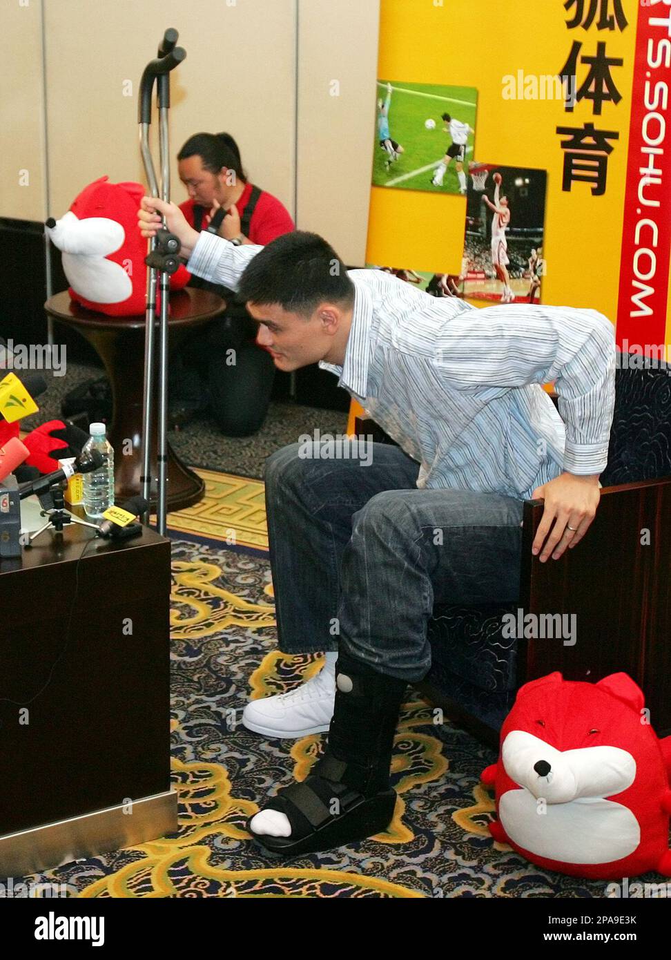 Chinese NBA star Yao Ming gets up after a press conference in Beijing ...