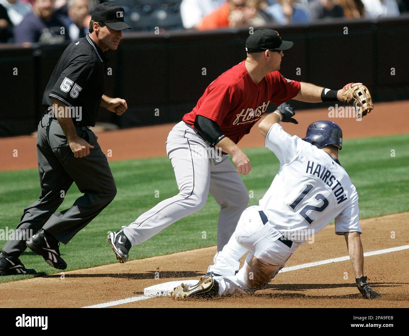 San Diego Padres' Scott Hairston is safe at third while advancing on a ...
