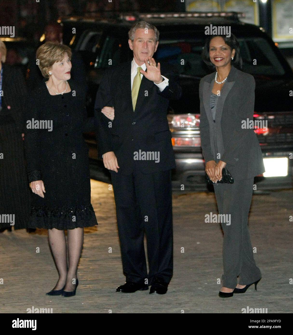 President Bush, center, accompanied by first lady Laura Bush, left, and ...