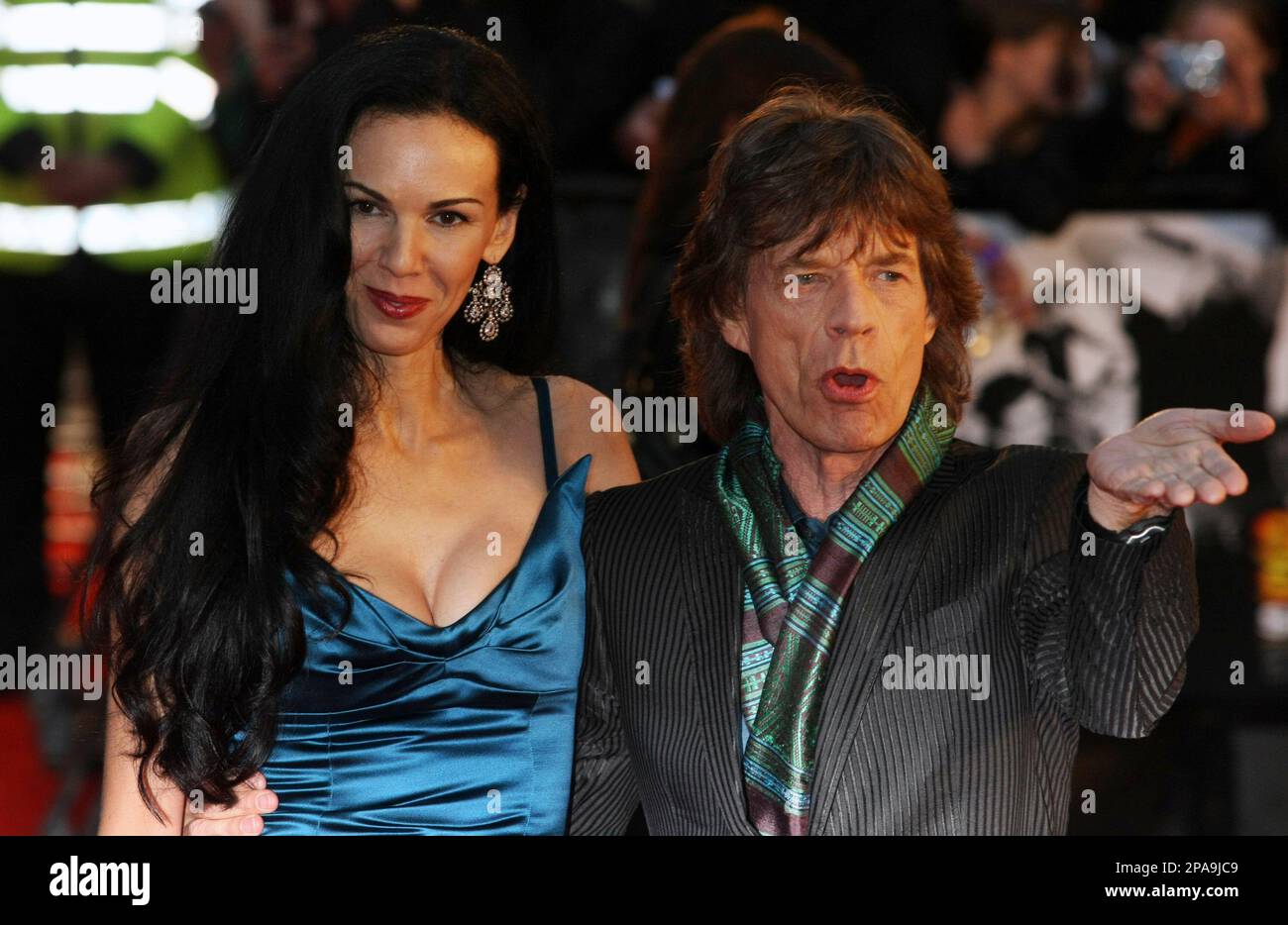 Mick Jagger of the The Rolling Stones, right, poses for photographers ...