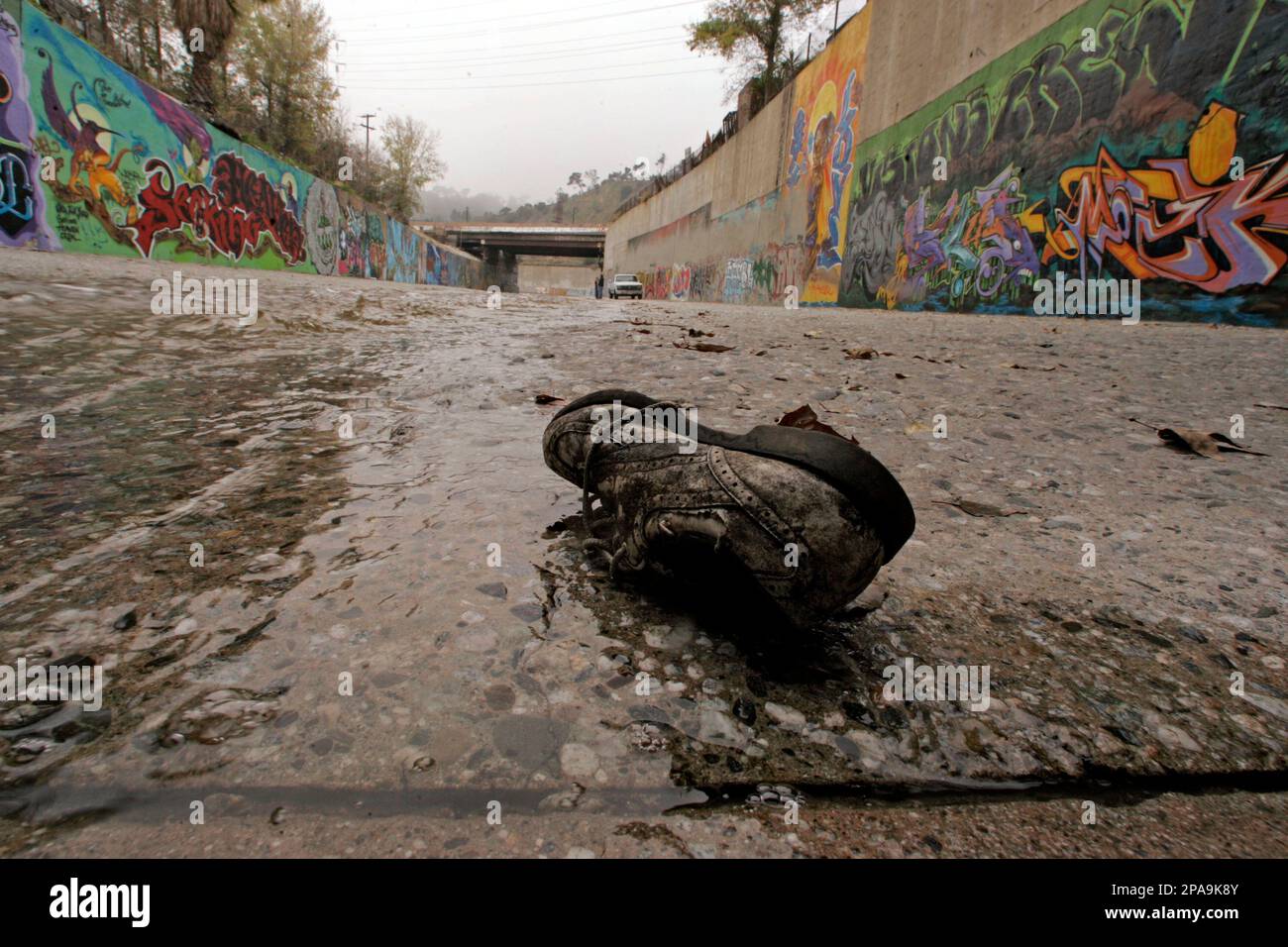 An abandoned shoe is seen on the bottom of the Los Angeles River banks ...