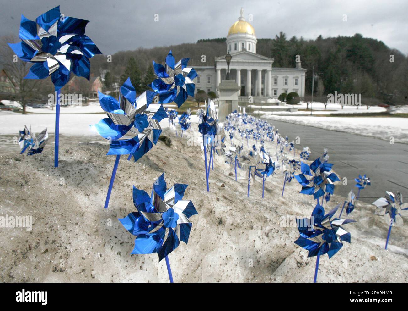 Pinwheels line the snow banks at the Statehouse in Montpelier, Vt., Tuesday, April 1, 2008. The ...