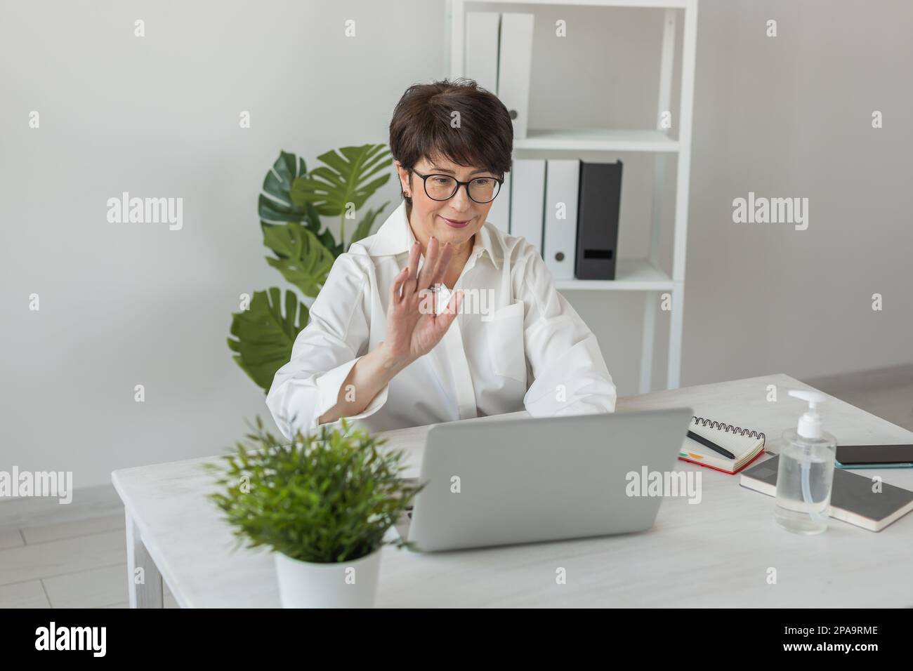 Businesswoman working in office doing video call with laptop. Female ...