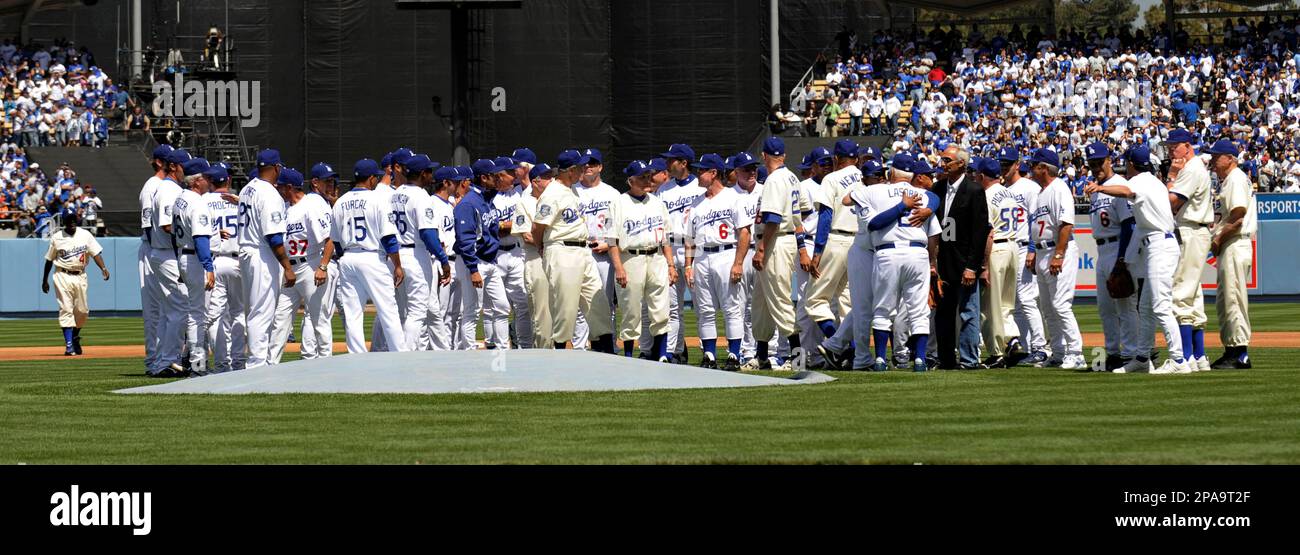Former Los Angeles Dodgers players gather in the infield to celebrate ...