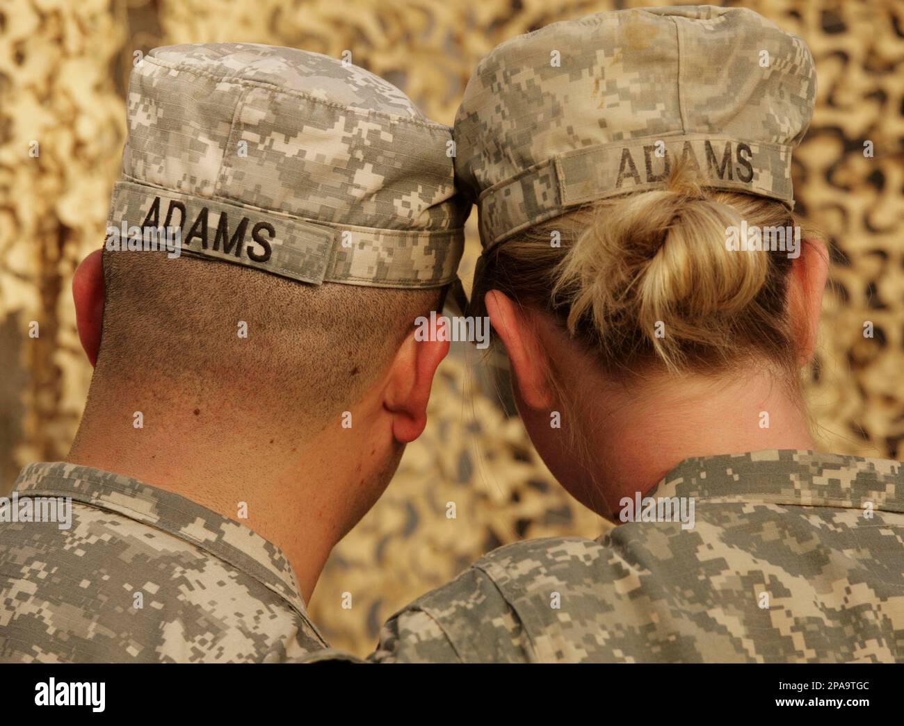 U.S. Army Sgt. Cameron Adams, 29, left, and his wife, Spc. Chelsea ...