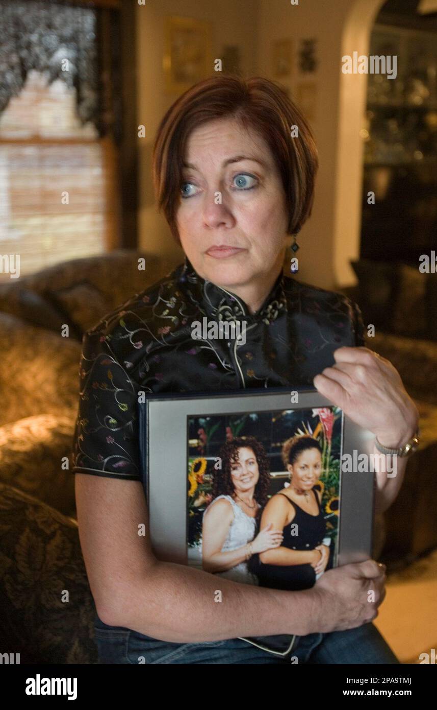 Linda Ramsey holds a photo of herself and her daughter Amber, who was ...