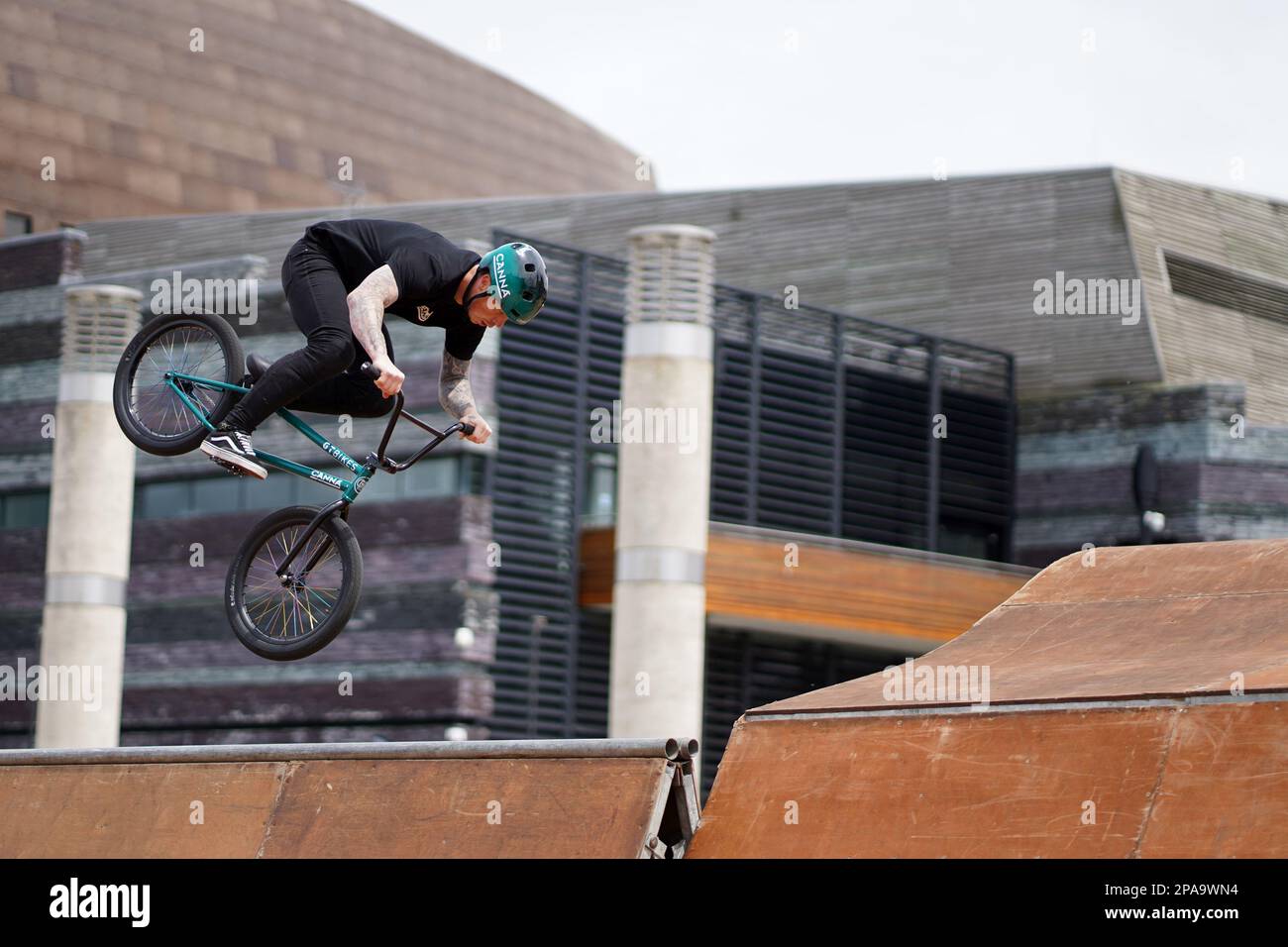 Members of Team Extreme performing BMX Bike tricks on the half pipe at ...
