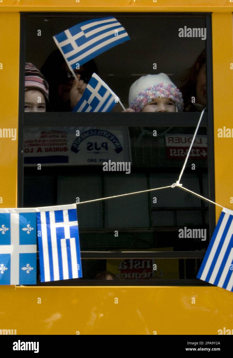 Children wave small flags as members of the Greek community celebrate ...