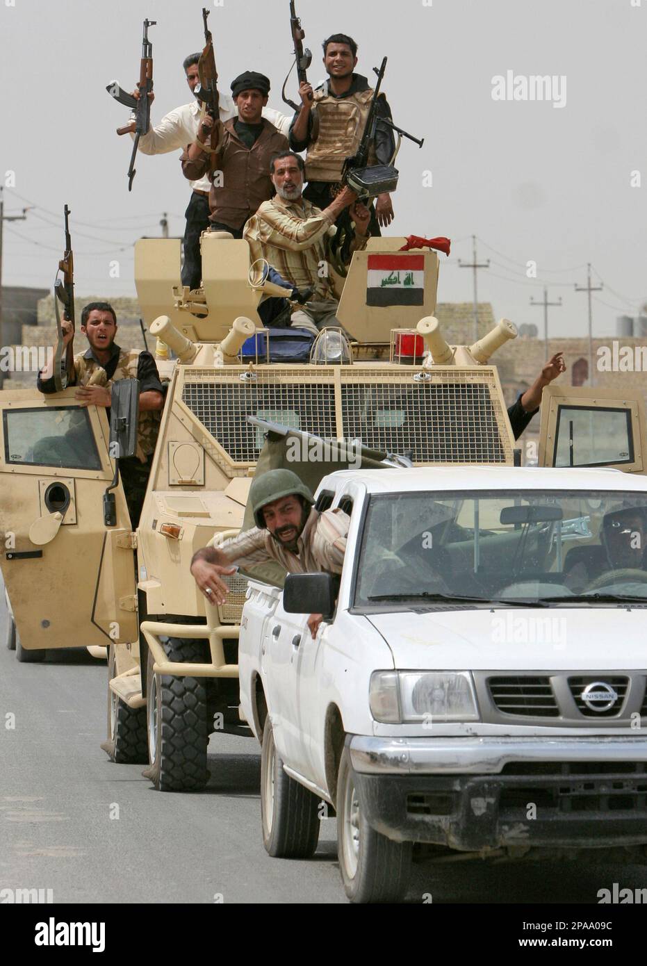 Mahdi Army fighters drive away with captured Iraqi police vehicles ...