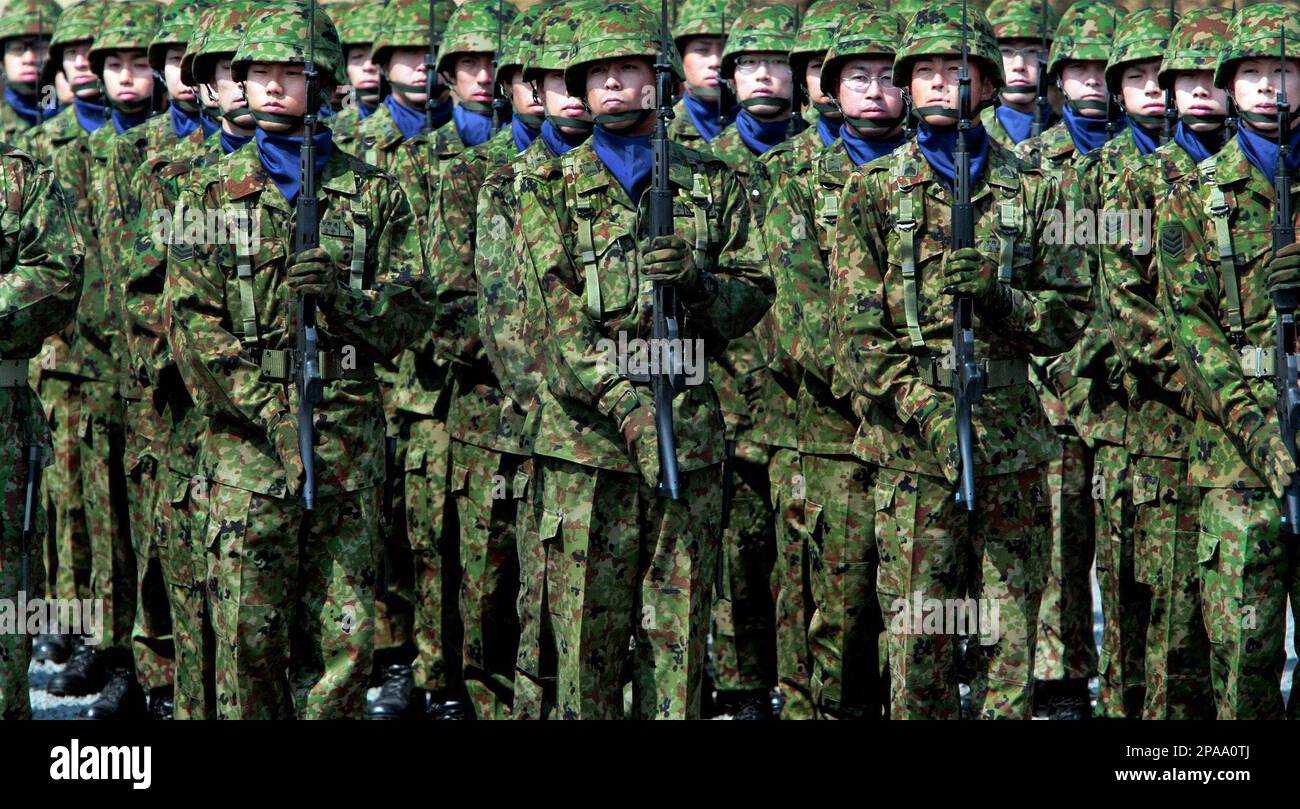 Japan Ground Self-Defense Force personnel stand at attention during the ...